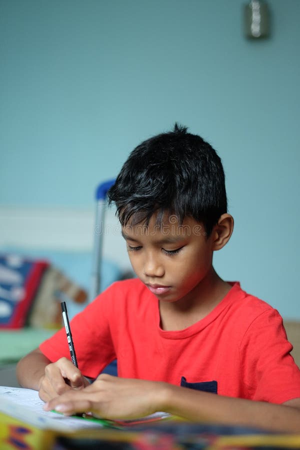 A boy study at his bedroom stock photo. Image of book - 117719614