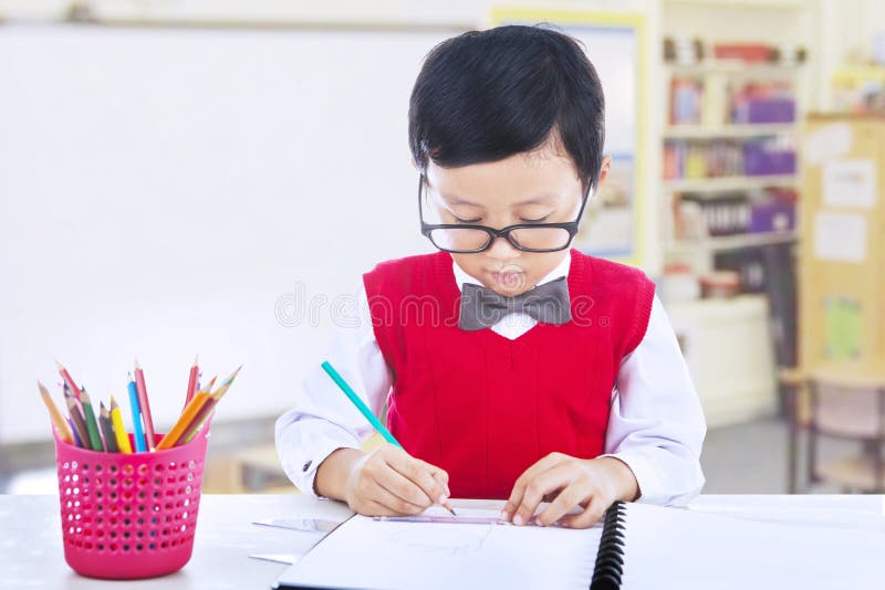 Boy studying in classroom stock photo. Image of education - 29072294