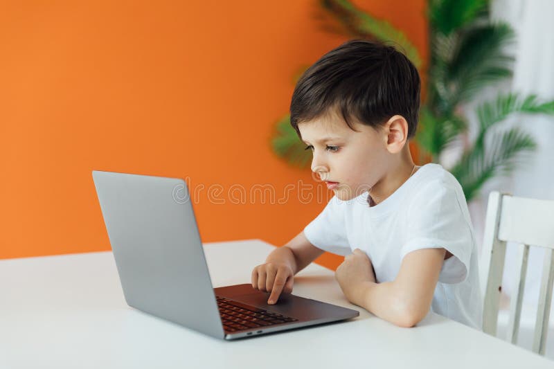Boy Studying Playing on Laptop Online at Table Stock Photo - Image of ...