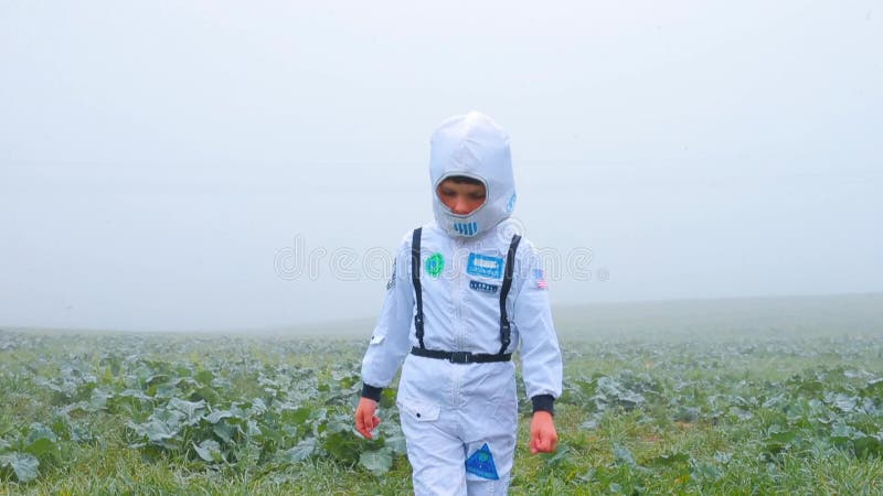 A Boy in an Astronaut Costume Backs Back in the Field Stock Video ...