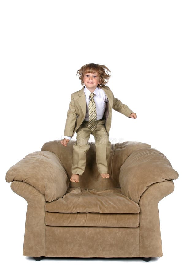 Boy In Suit Jumping On Chair Stock Image - Image of handsome, bounce ...