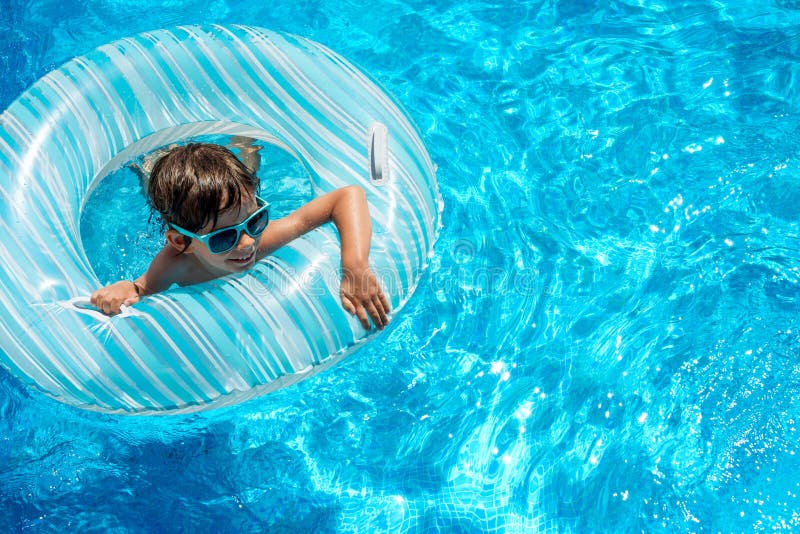 Boy in Sunglasses Swims in Pool with Float Stock Image - Image of swims ...