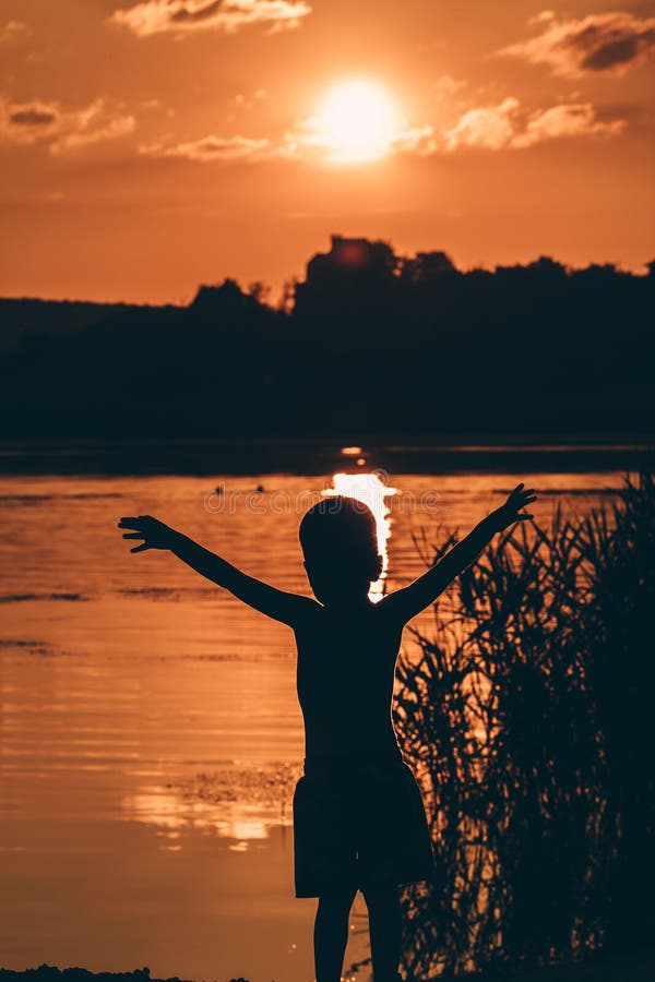 Boy on Sunset Background Over Summer River. Stock Photo - Image of ...
