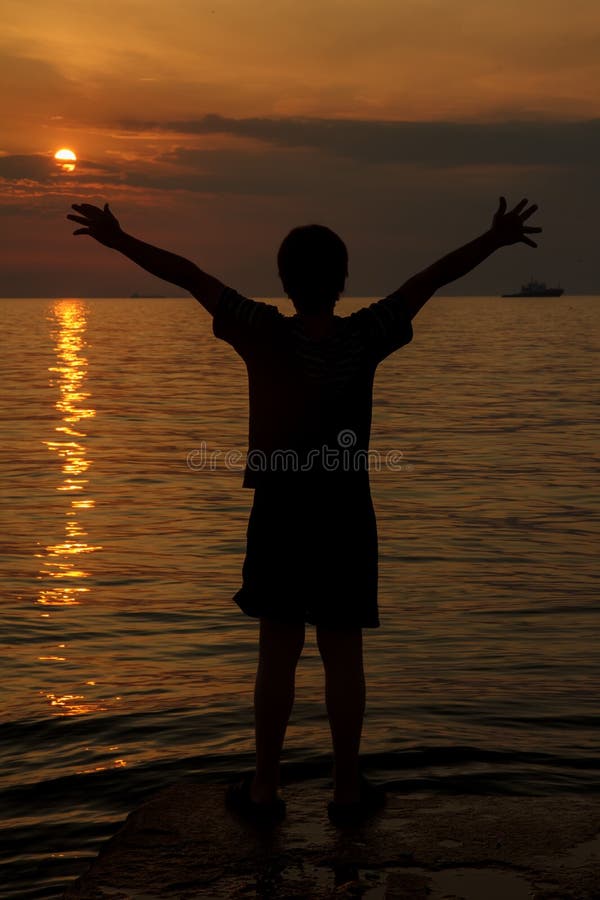 Boy at sunset over the sea stock image. Image of horizon - 33833465