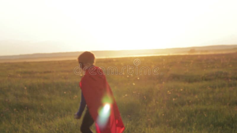 Boy Superhero in a Field at Sunset Stock Video - Video of cape, happy ...