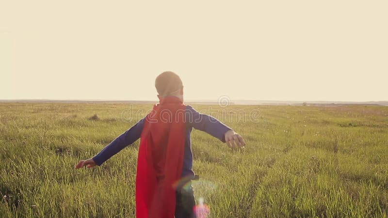 Boy Superhero in a Field at Sunset Stock Video - Video of muscles ...