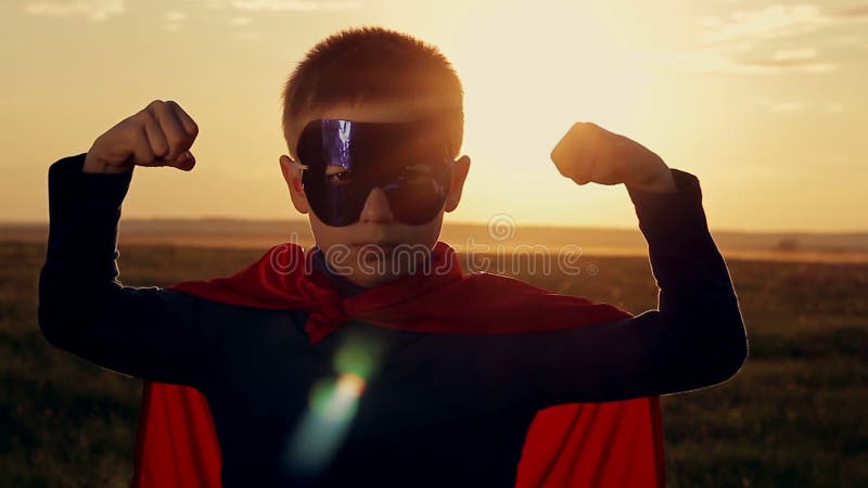 Video: Boy superhero in a field at sunset, Superhero boy running on the ...