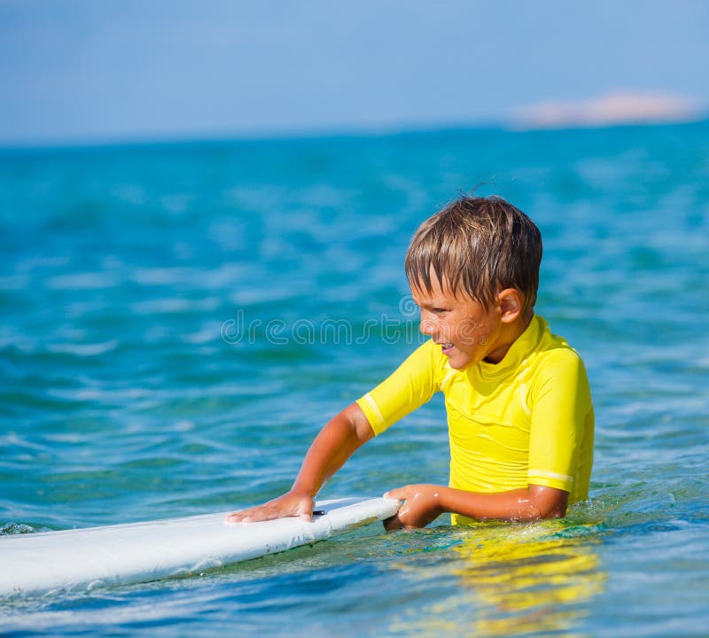 Boy with surf stock image. Image of child, leisure, surfboard - 54089117