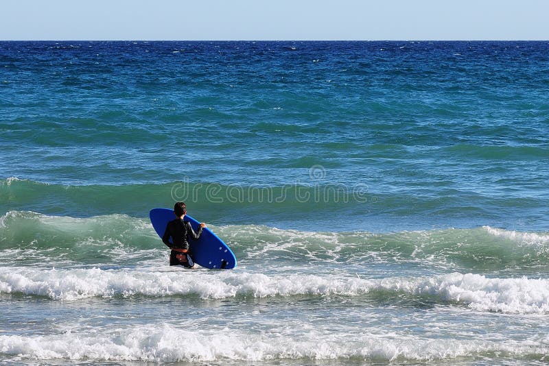 Boy with Surfboard Standing in the Water. Editorial Photo - Image of ...