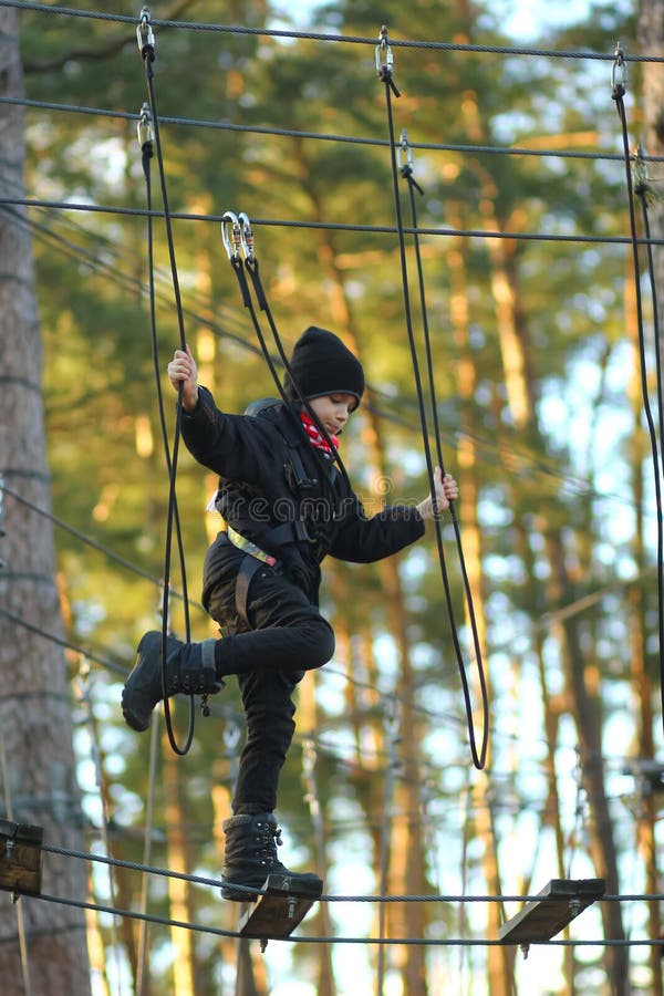 Boy Surmounting Obstacle Course in the Outdoor Rope Park Stock Image ...