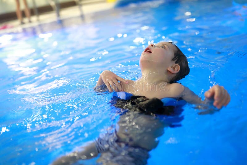 Boy swimming on his back stock image. Image of aquatic - 133285233
