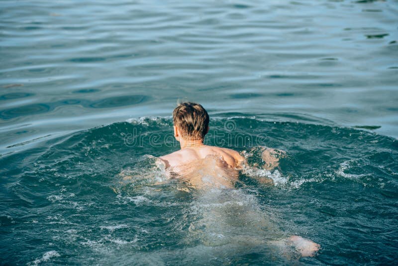 Boy Swimming in the Lake in Summer-view from the Back. Stock Photo ...