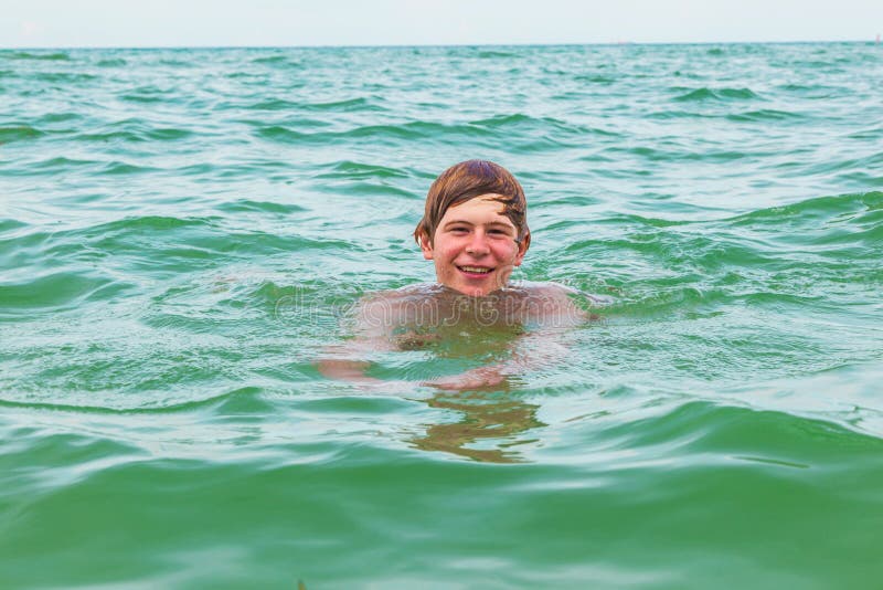 Boy swimming in the ocean stock image. Image of clean - 62773271