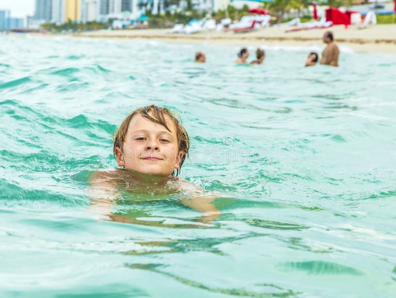 Boy is Swimming in the Ocean Stock Image - Image of froth, america ...