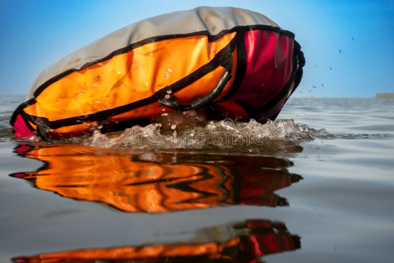 The Boy Swims in the Water with the Help of an Inflatable Ring Stock ...