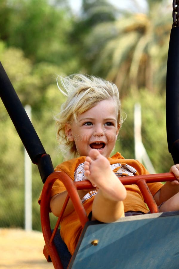 Boy on a swing stock photo. Image of little, playground - 15779590