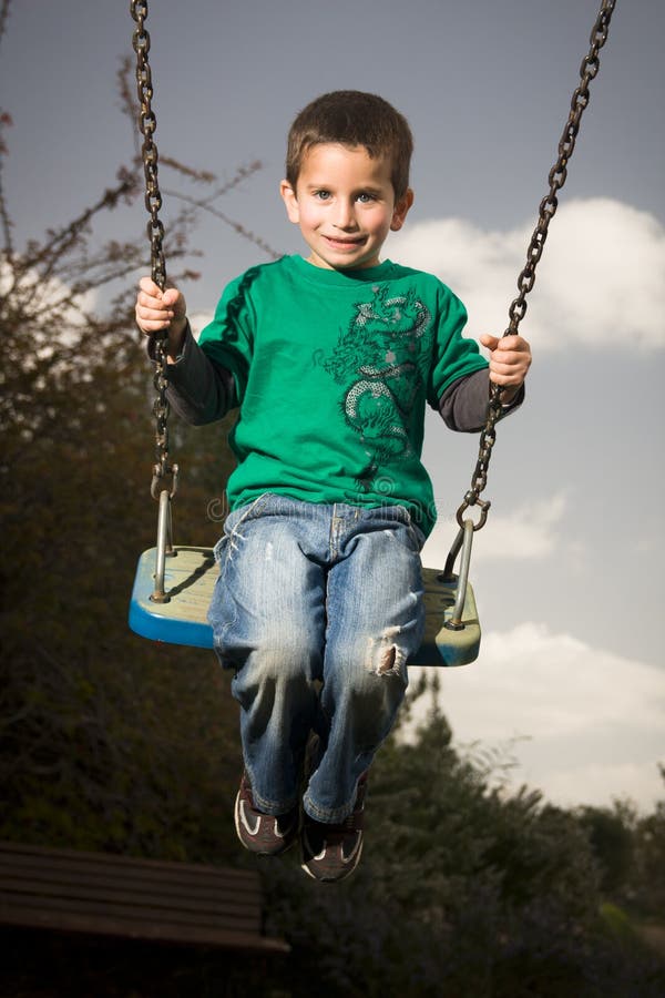 Boy on swing stock image. Image of laughing, happy, brunette - 18556427