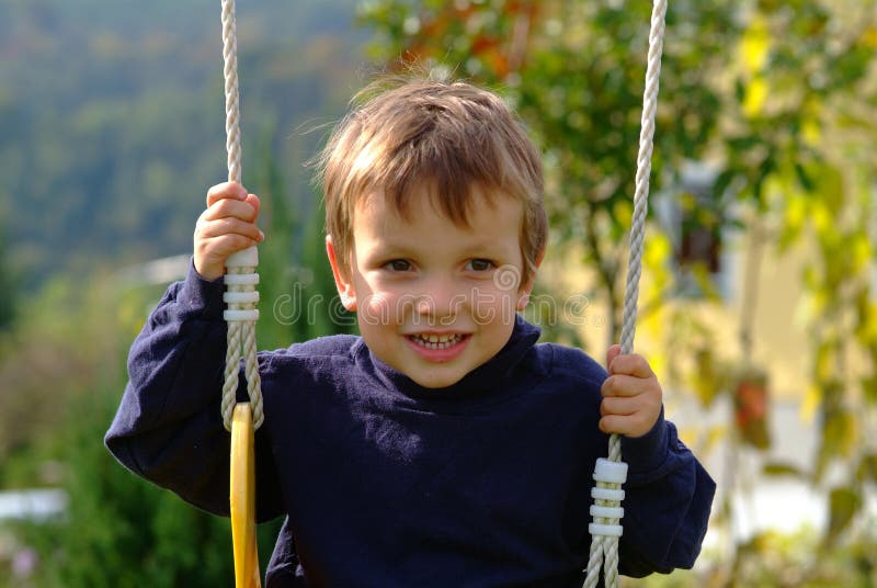 Boy on the swing stock photo. Image of casual, kids, child - 2822054