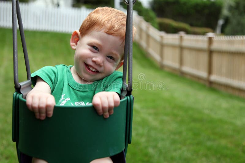 Boy on swing stock photo. Image of eyes, hair, beautiful - 9921074