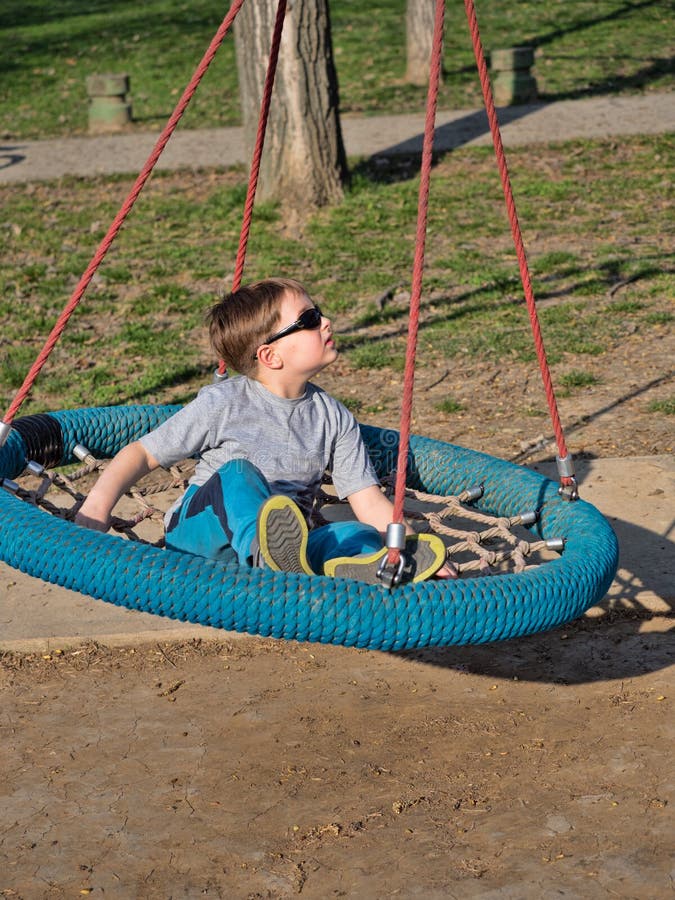 Boy on swing stock photo. Image of play, active, nature - 245571672