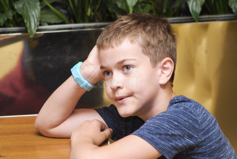 Boy at a table in a cafe stock image. Image of adorable - 163413311