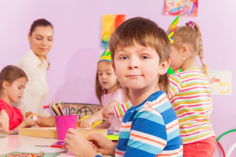 Boy by the Table in Kindergarten Class with Mates Stock Image - Image ...