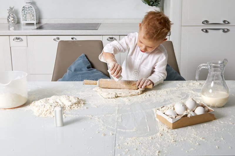 The Boy Cheerfully Prepares a Pie from the Dough Stock Photo - Image of ...