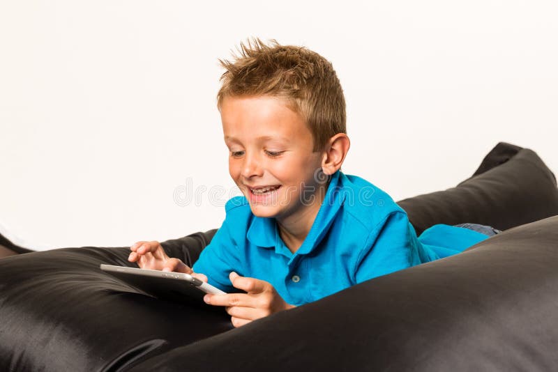 Boy tapping on tablet stock image. Image of children - 41592383
