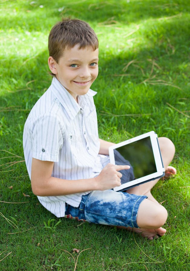 Boy with tablet outdoors stock photo. Image of children - 50854904