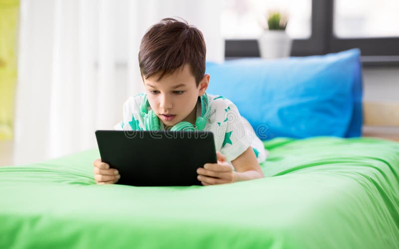 Boy with Tablet Pc Computer Playing Game at Home Stock Photo - Image of ...