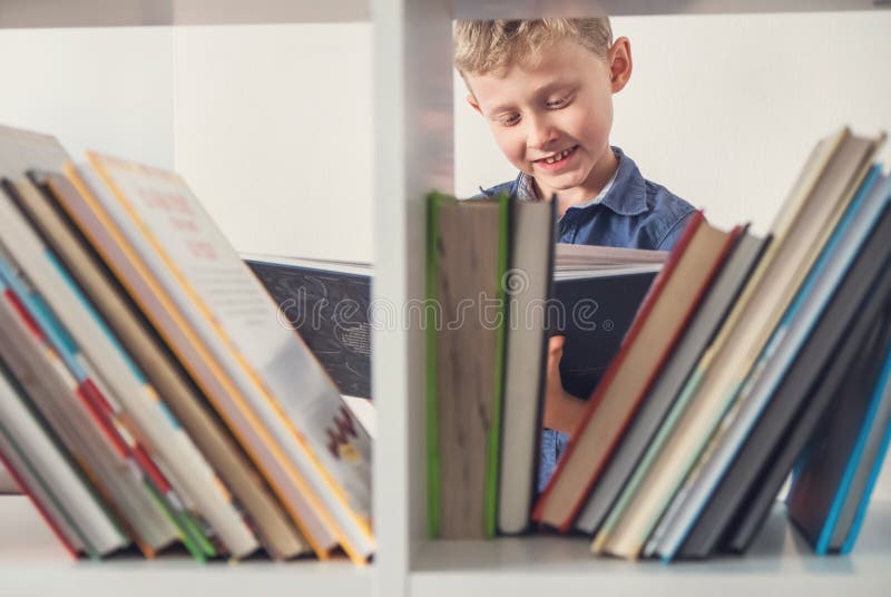 Boy Take a Book from the Book Shelf Stock Image - Image of library ...