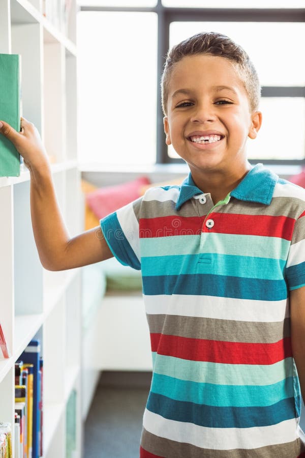 Boy Taking a Book from Bookshelf in Library Stock Photo - Image of ...
