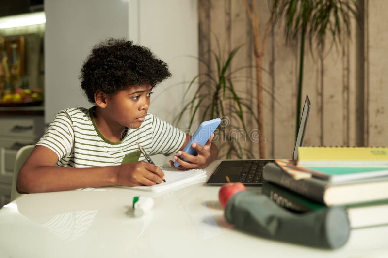 Boy Taking Notes during Home Learning Stock Image - Image of ...