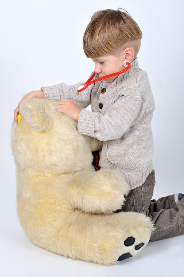 Boy with a teddy bear stock photo. Image of looking, toys - 29483450