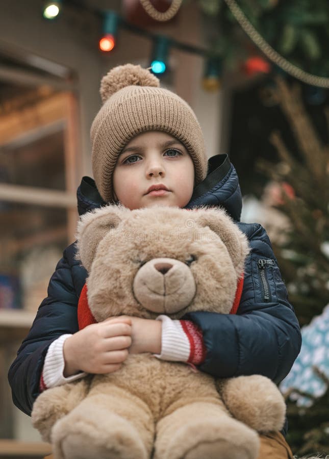 A boy and a teddy bear stock photo. Image of face, baby - 242214136