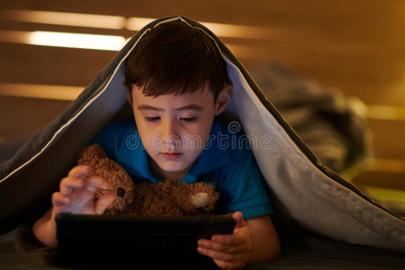 Boy Playing Game on Tablet at Night Stock Image - Image of late ...