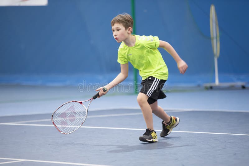 A boy with a tennis racket stock image. Image of activity - 222777129