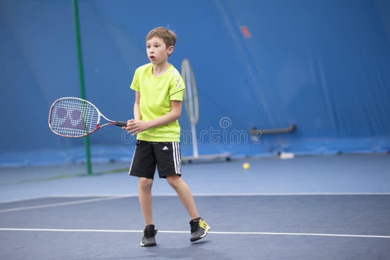 A boy with a tennis racket stock image. Image of match - 222777253
