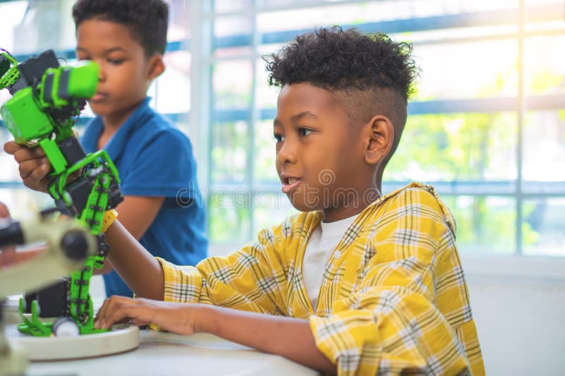 An African American Boy is Setting Robot Kit in Robotic Classroom ...