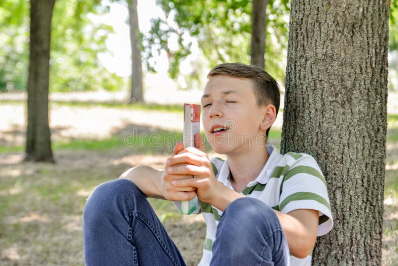 A Boy with a Textbook Under a Tree is Preparing for School Assignments ...