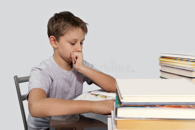 Boy thinking on homework stock photo. Image of desk, pile - 49910288