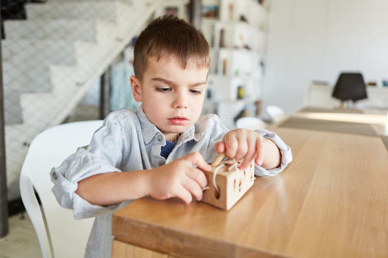 Boy Threading a String on a Wooden Toy Stock Photo - Image of thread ...