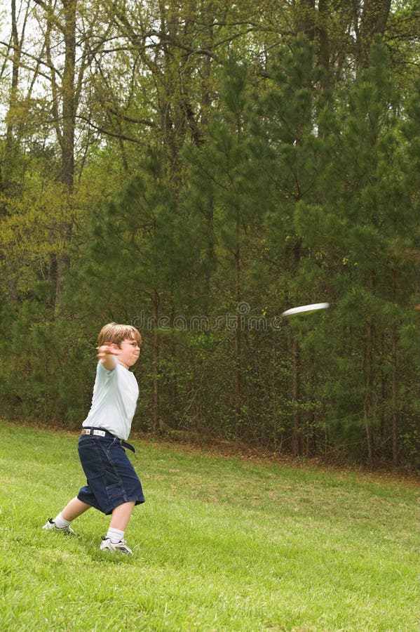 Boy throwing frisbee stock image. Image of leafy, male - 4872905