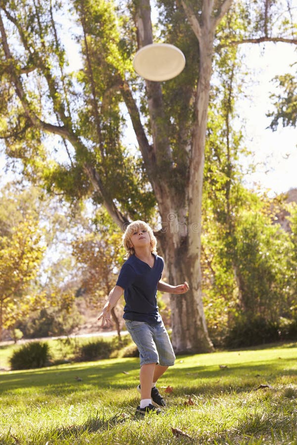 Boy throwing frisbee stock image. Image of leafy, male - 4872905