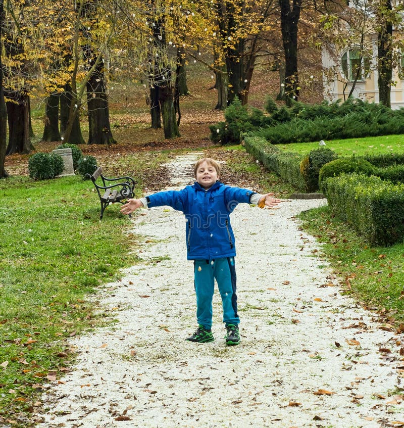 Boy throwing pebbles stock photo. Image of outside, park - 81324520