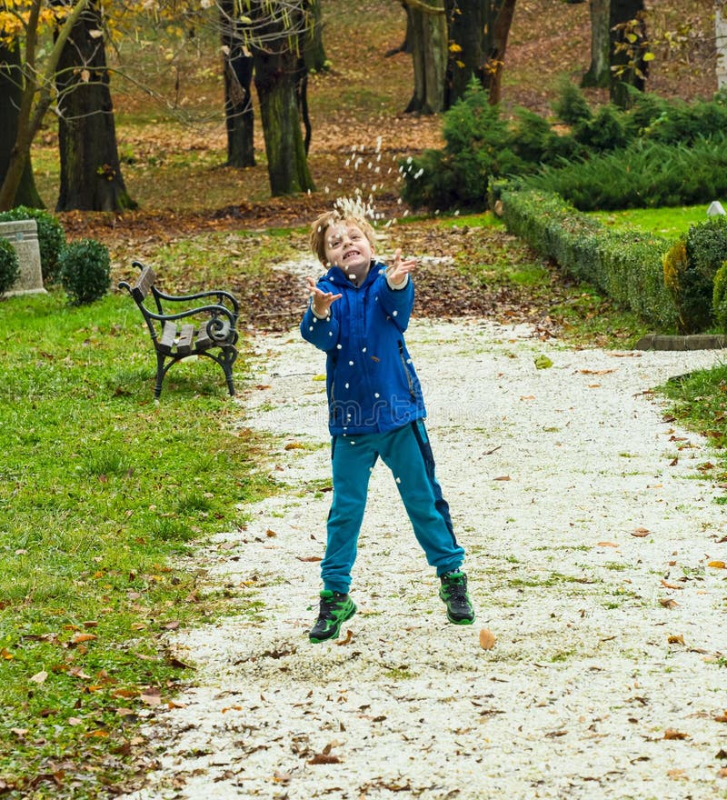 Boy throwing pebbles stock photo. Image of enjoyable - 81324592