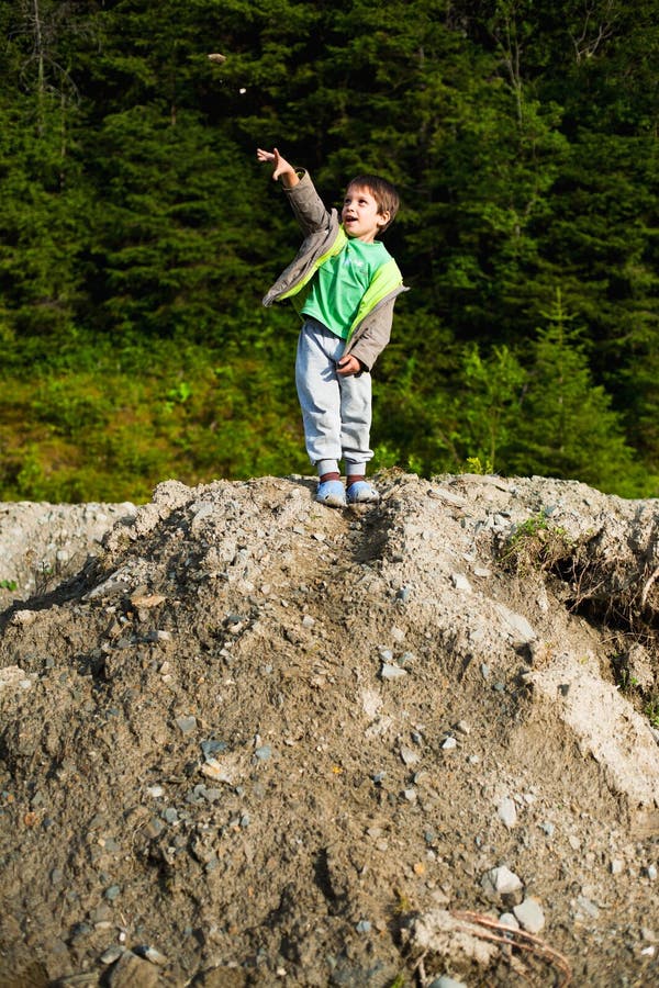 Boy throwing rock stock photo. Image of forest, outdoors - 36497770