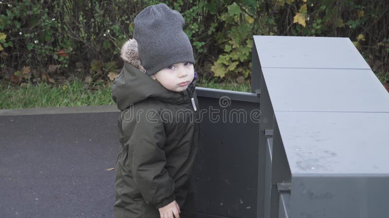 Boy throwing trash stock footage. Video of environment - 201150462
