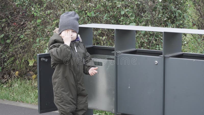 Boy throwing trash stock footage. Video of environment - 201150462