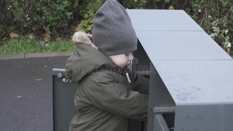 Boy throwing trash stock footage. Video of environment - 201150462